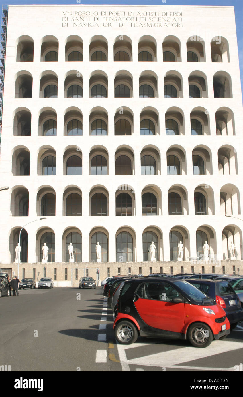 Red Smart car parked outside the Palazzo della Civilita or Square ...