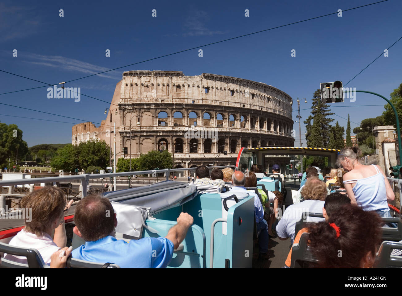 Tourists view Colosseum from a double decker tourist bus Rome, Italy ...