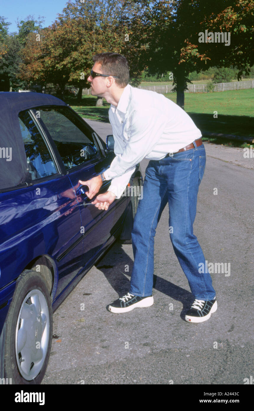 Man breaking in to car Stock Photo - Alamy