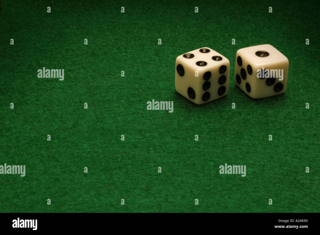 Dice on a green felt gambling table Stock Photo - Alamy