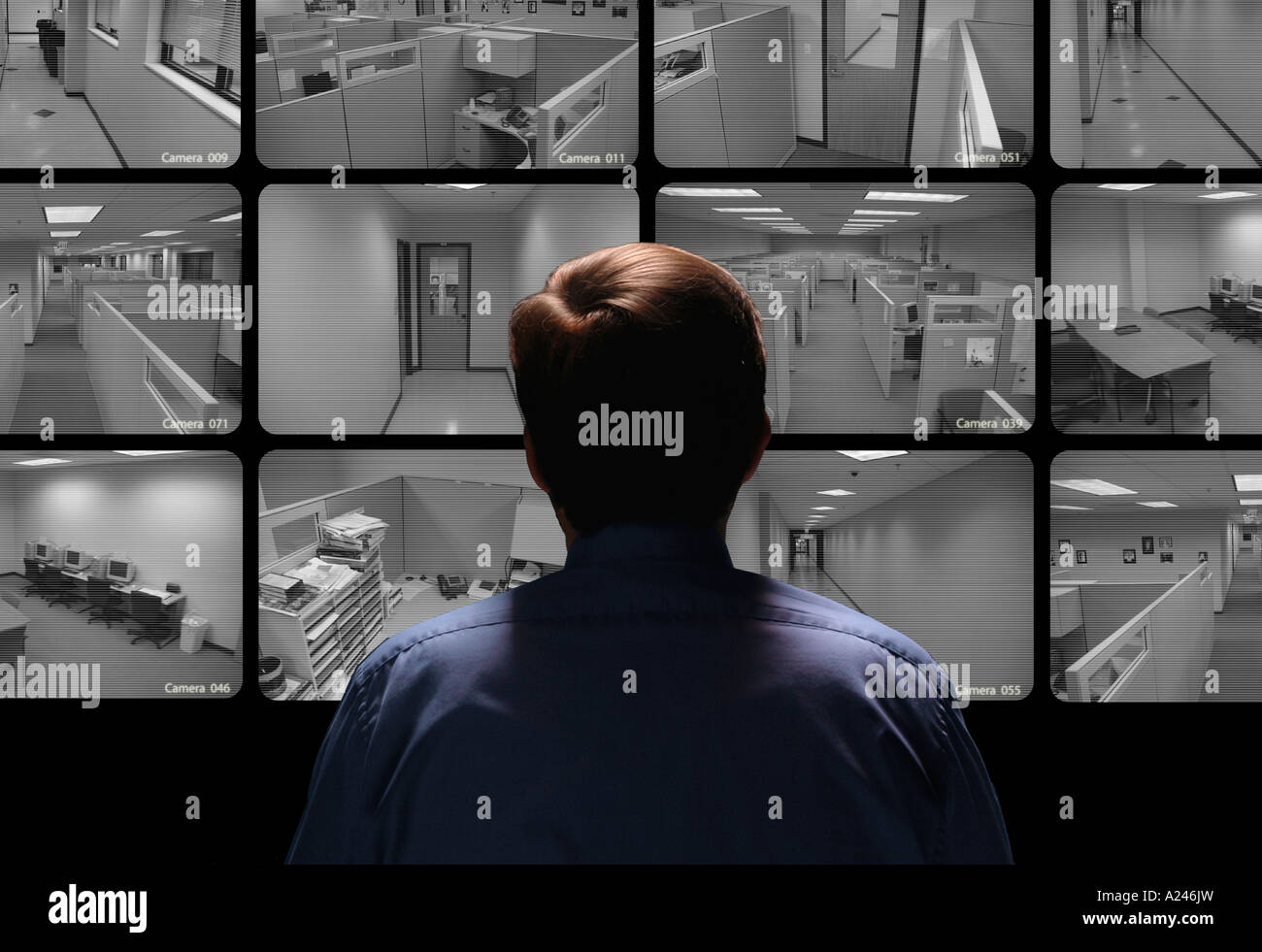 Security guard conducting surveillance by watching several security ...