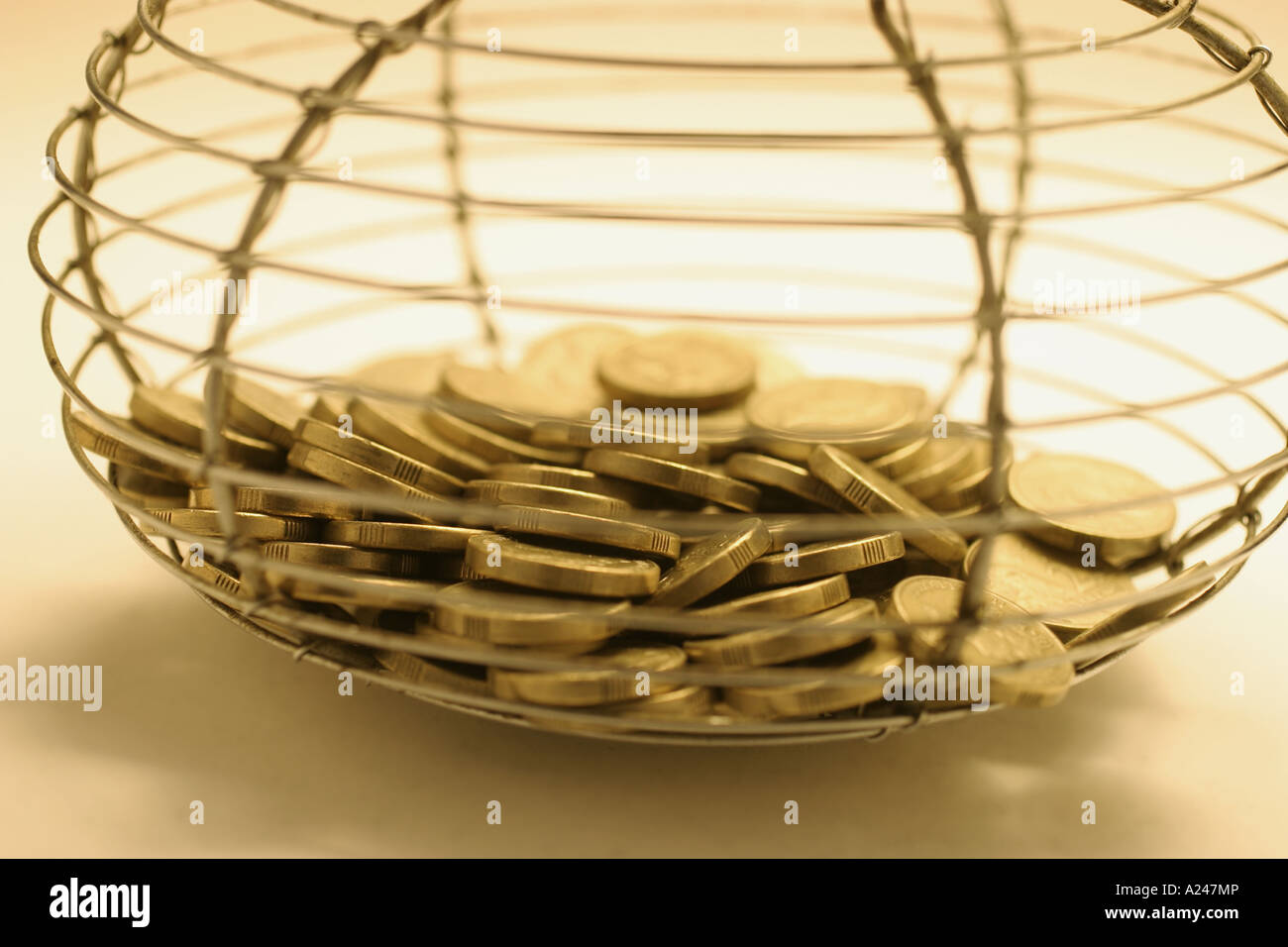 Coins in Wire Basket Stock Photo - Alamy