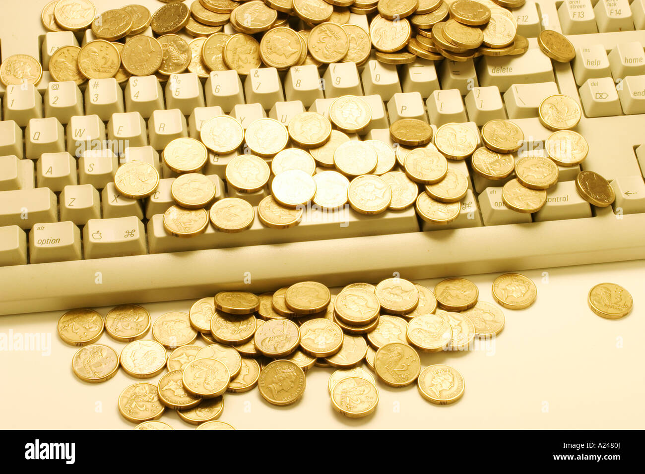 Coins on Computer Keyboard Stock Photo - Alamy
