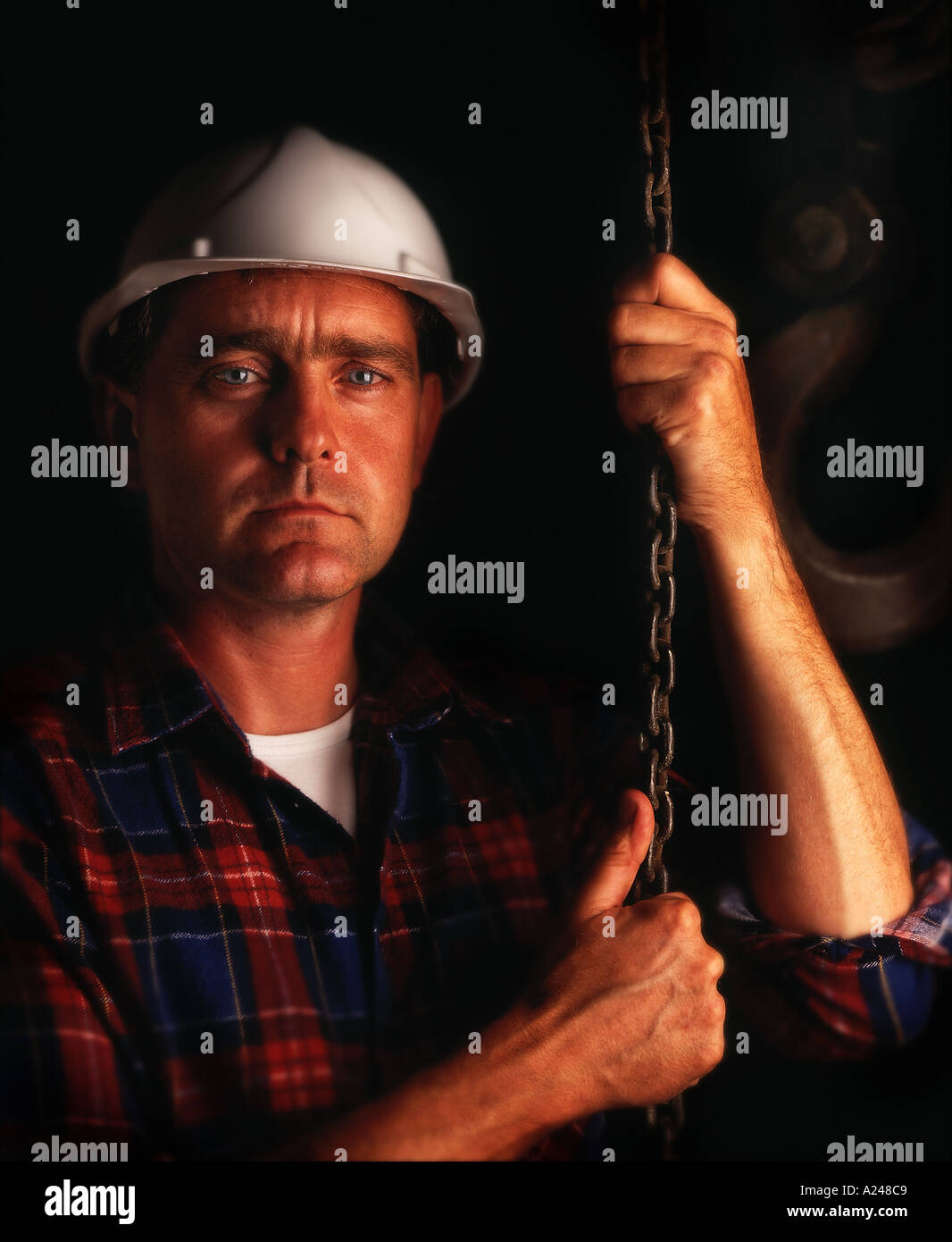 CONSTRUCTION WORKER WITH HARD HAT AND CHAIN Stock Photo - Alamy