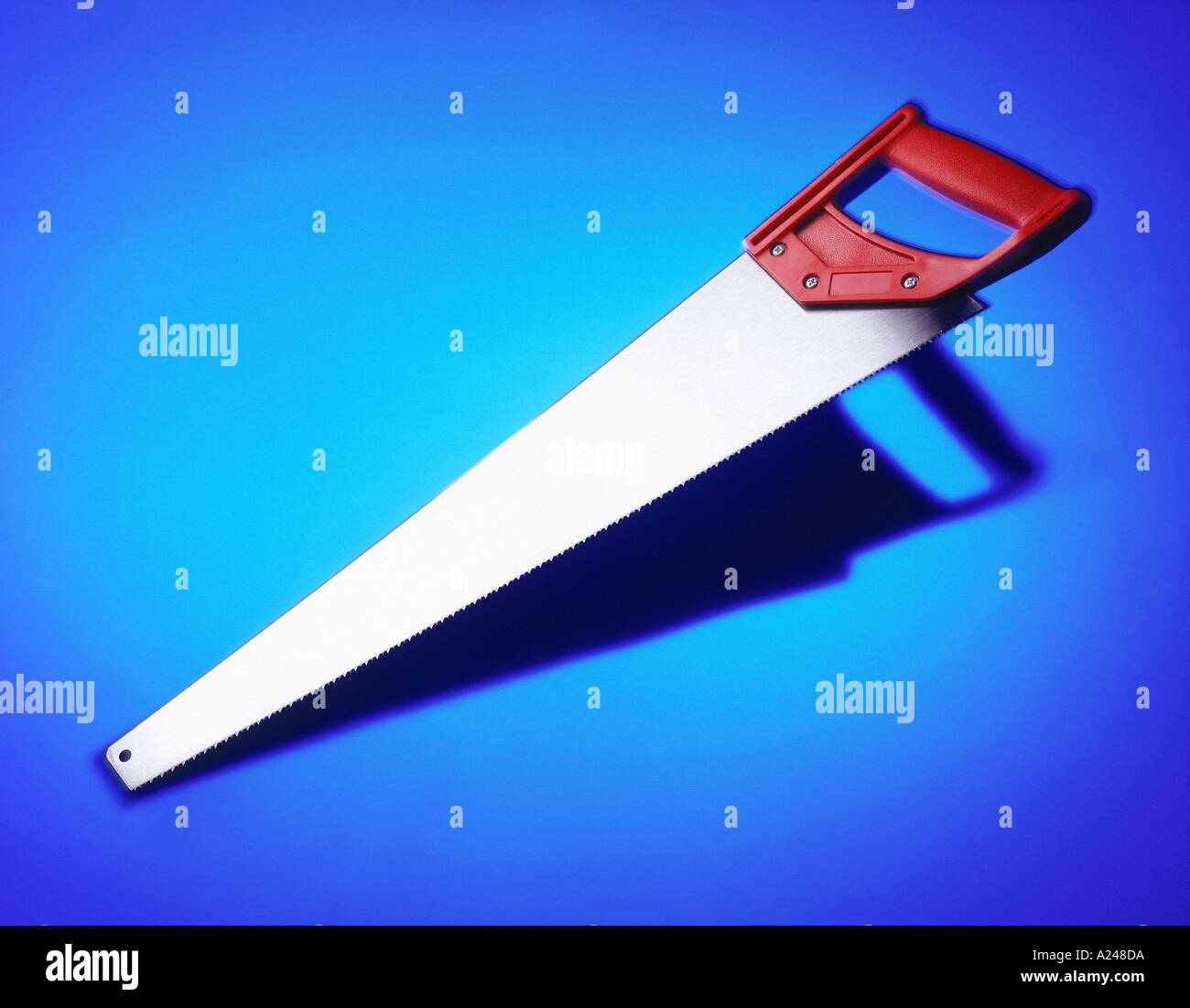 WOOD SAW ON BLUE BACKGROUND Stock Photo - Alamy