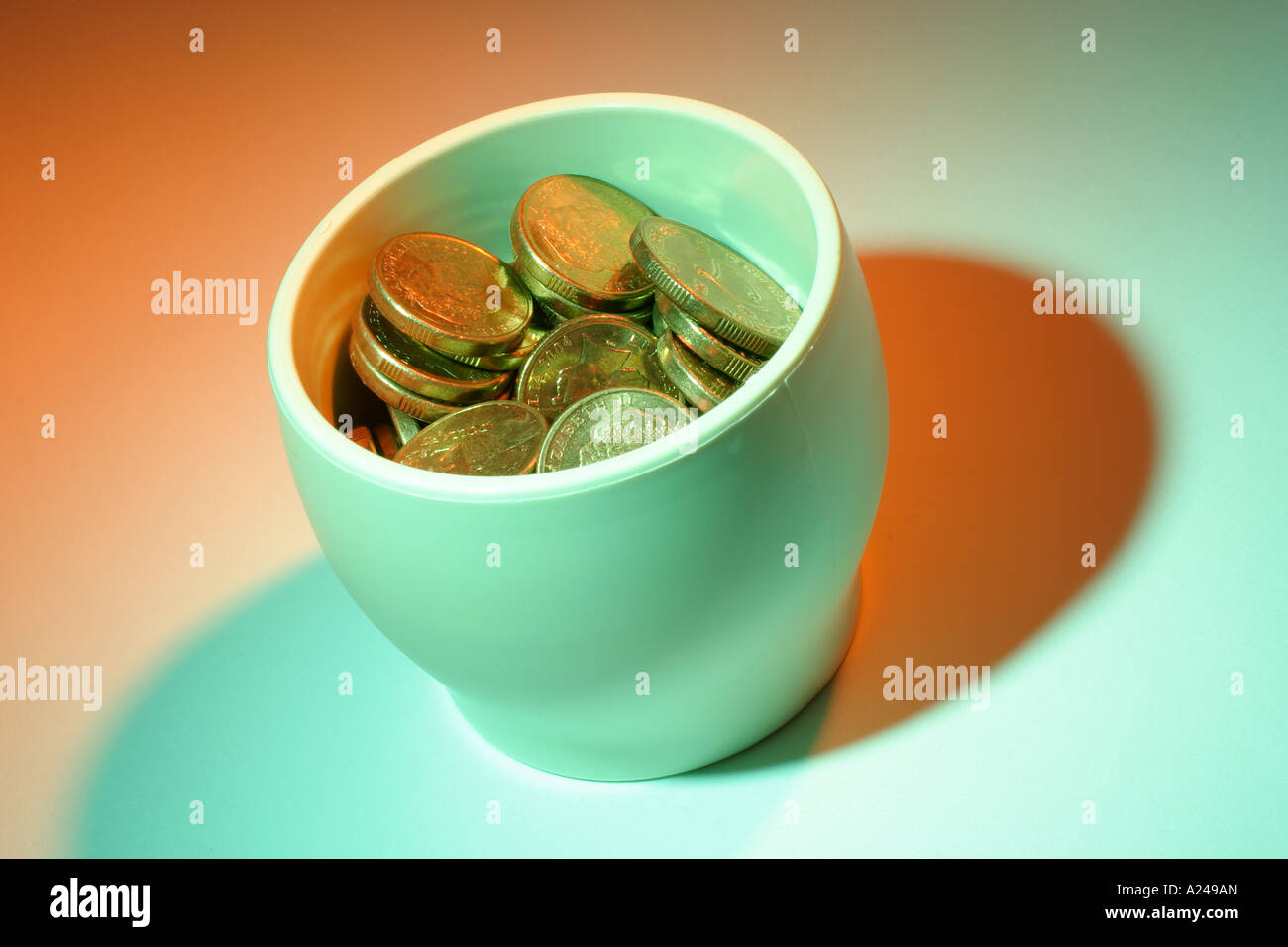Coins in Cup Stock Photo - Alamy