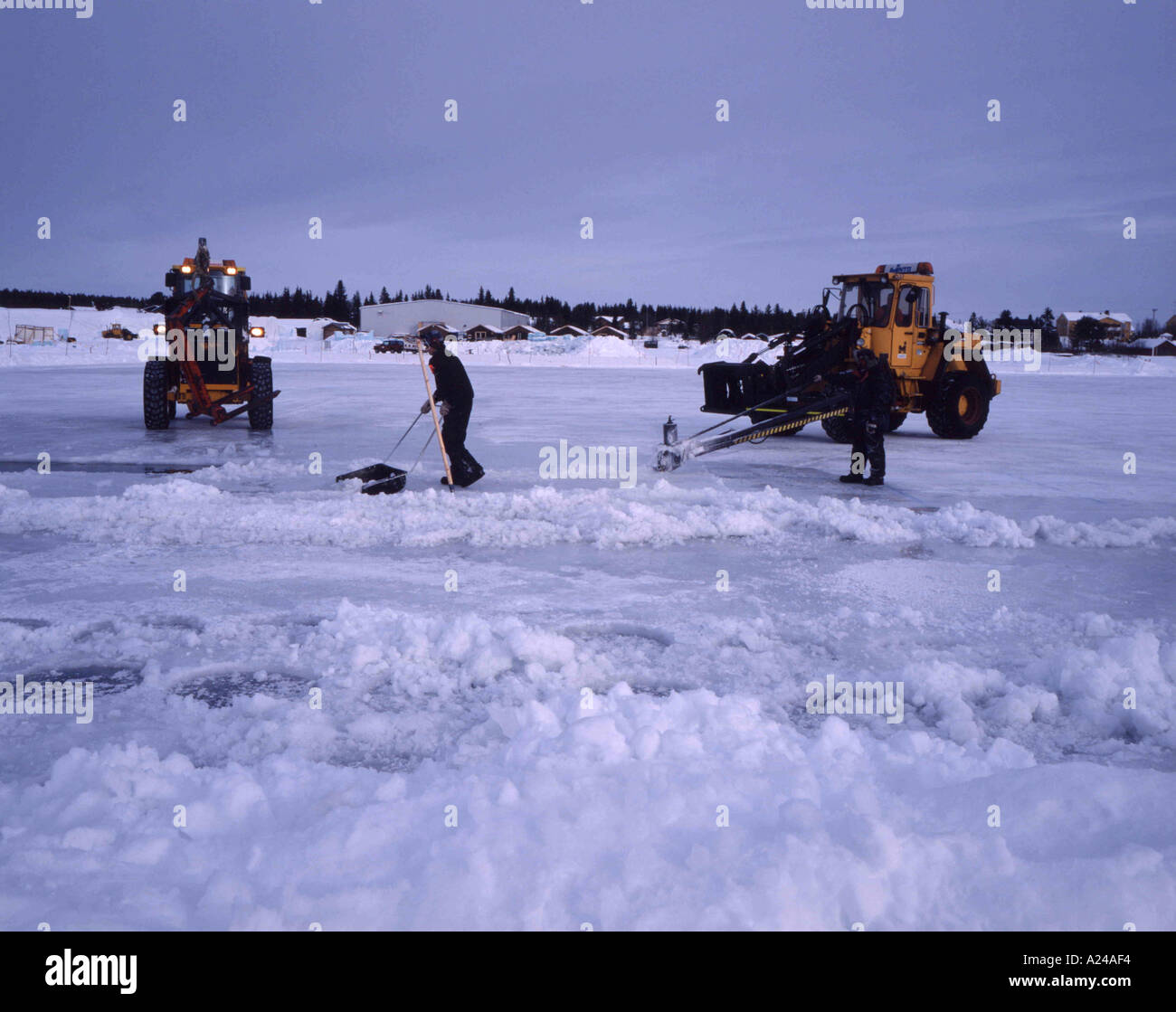 Men sweeping snow on the Tormealven River Jukkasjarvi Sweden Stock ...