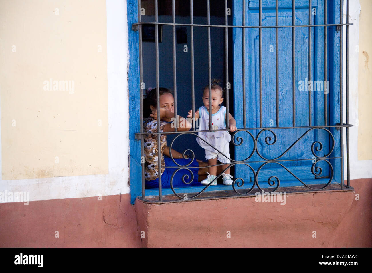 Mother and child in a window, Trinidad, Cuba Stock Photo - Alamy