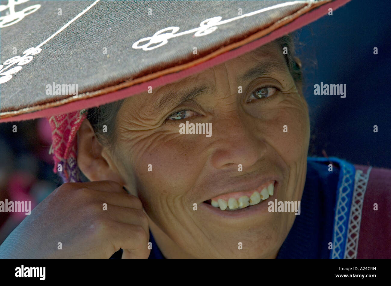 A head and shoulder portrait of a smiling local Hispanic Peruvian woman ...