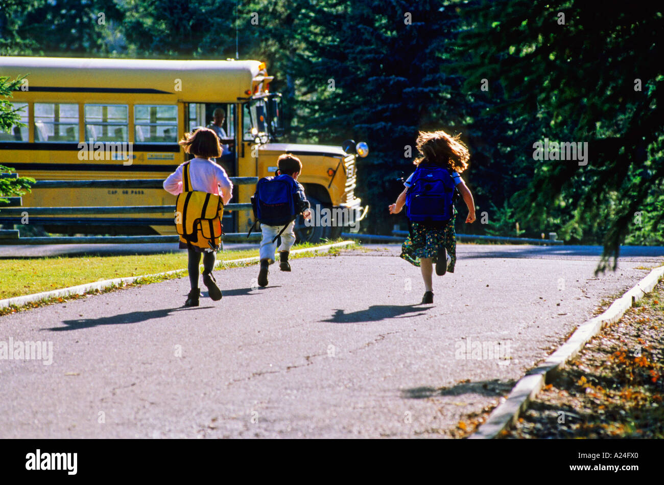 Children running for schoolbus Stock Photo - Alamy