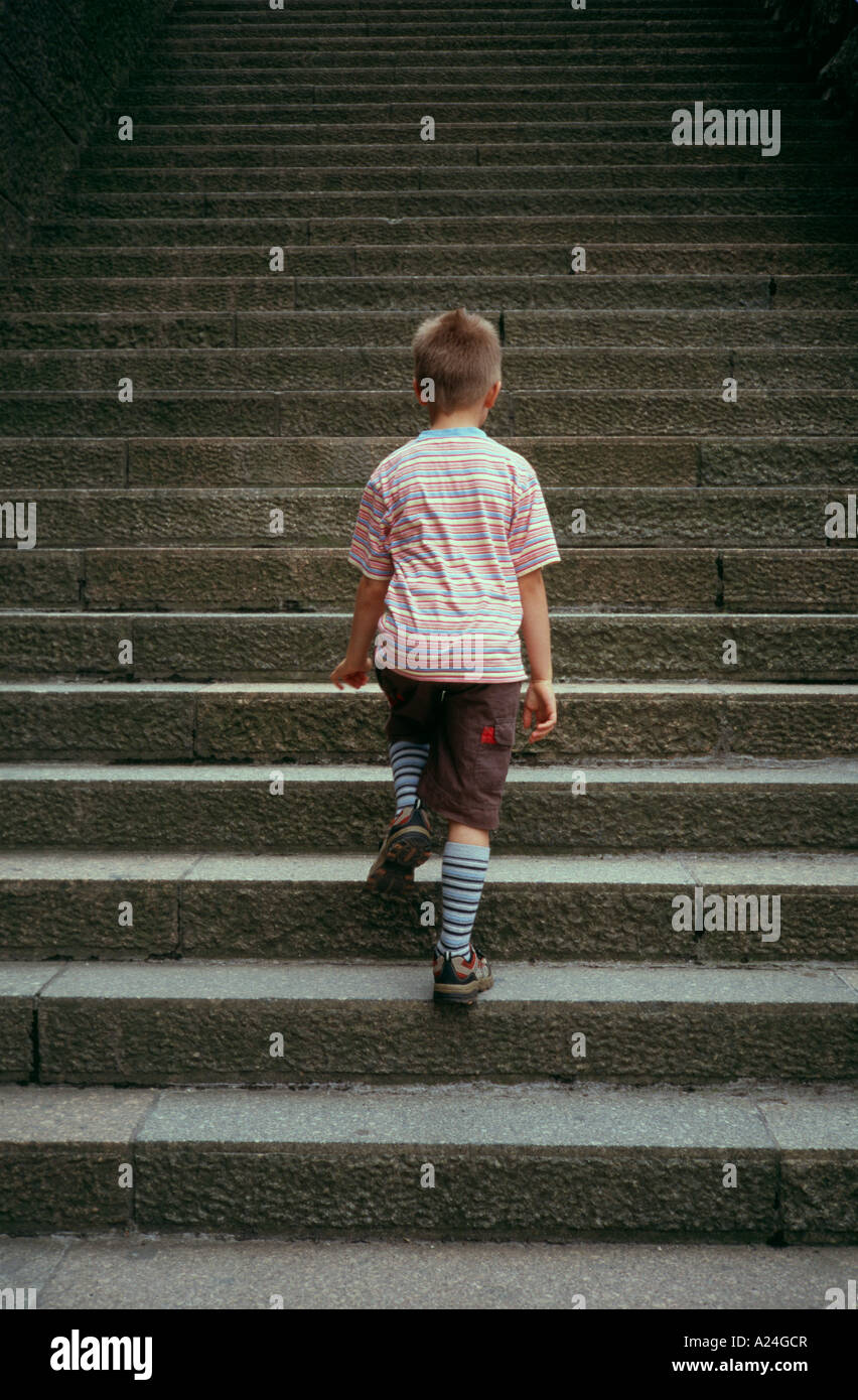 Boy climbing stairs hi-res stock photography and images - Alamy