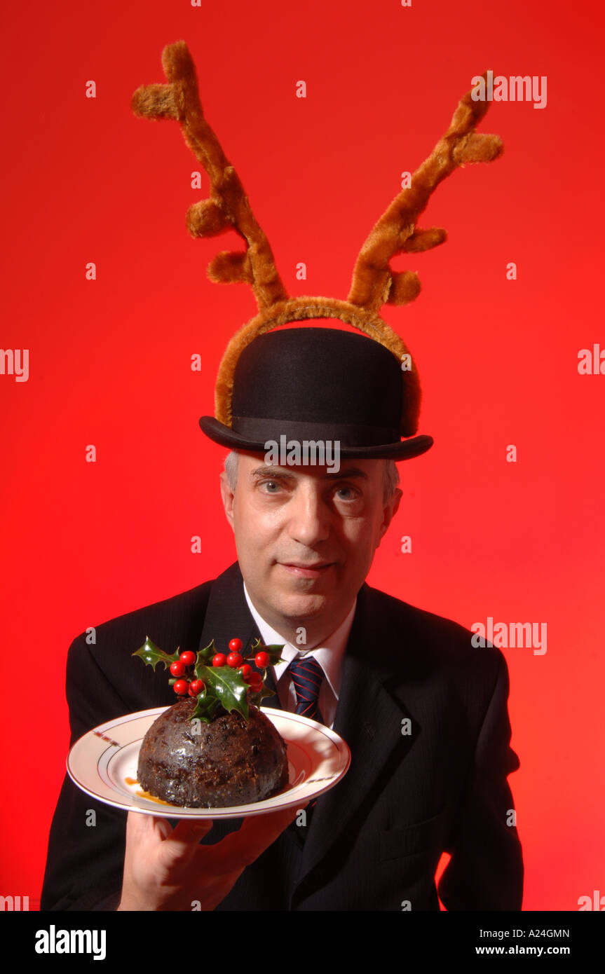 Traditional British city gent in bowler hat and comedy antlers holding ...