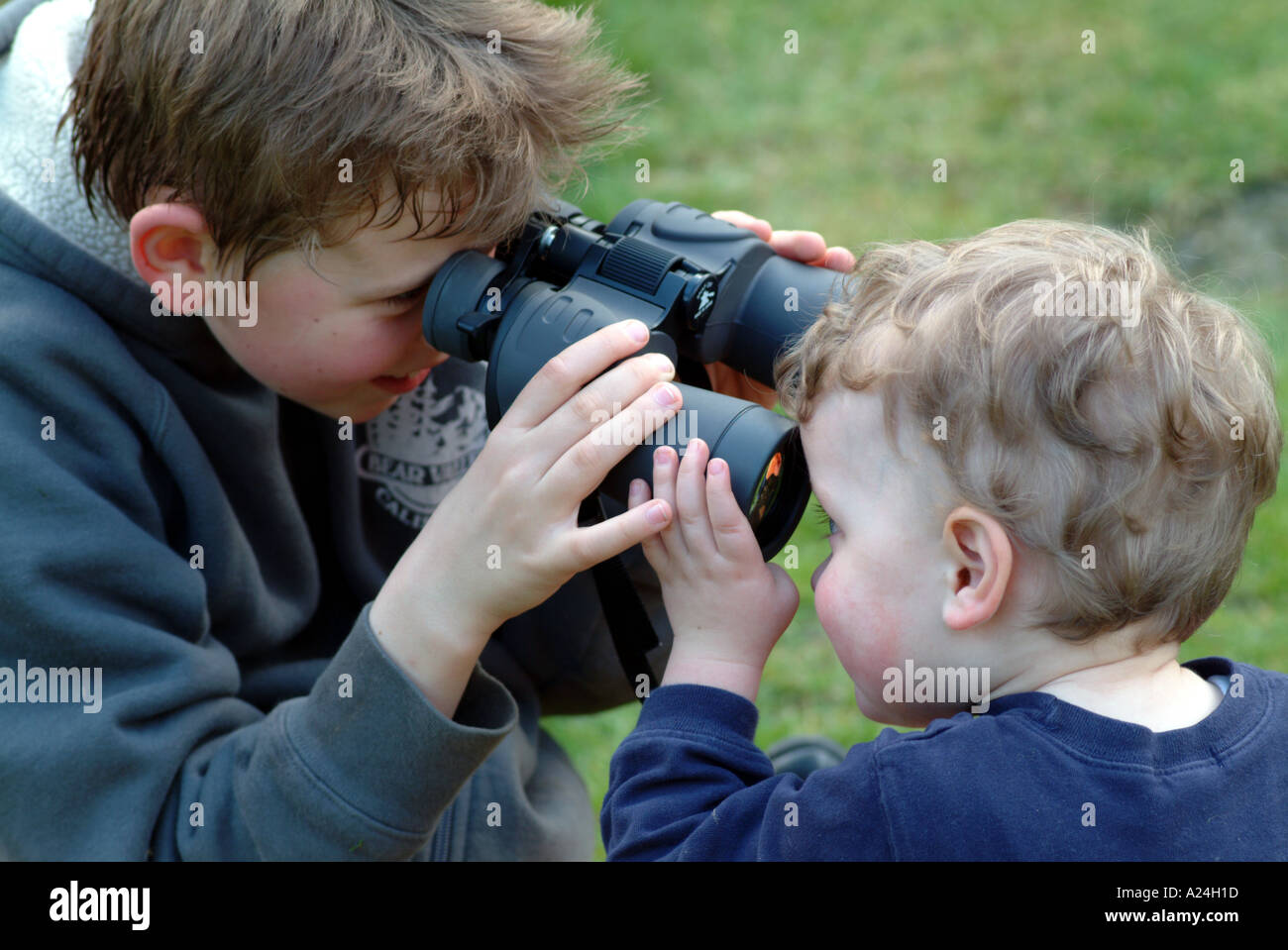 children having fun using binoculars Stock Photo - Alamy