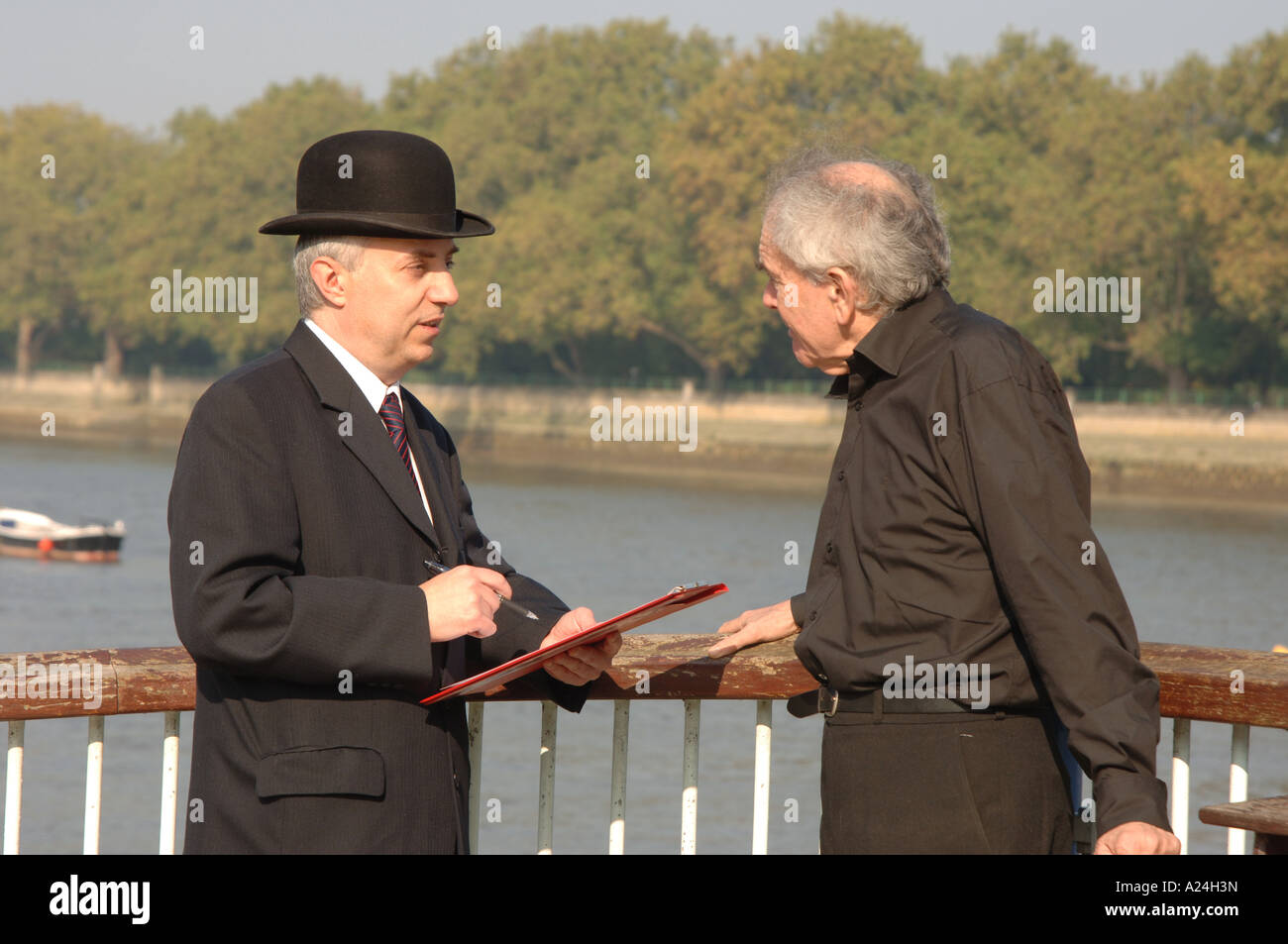 City gent interviewing senior citizen Stock Photo - Alamy