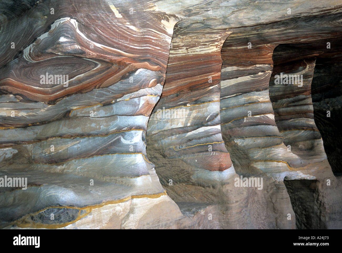 Nabataean caves in coloured rock Petra Jordan Stock Photo - Alamy