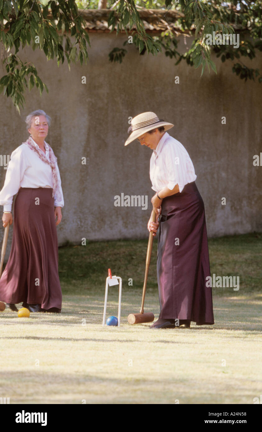 Croquet game players in Victorian Dress Lawn Grass Hoop Ball Mallet Man ...