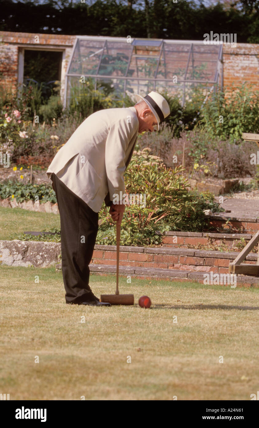 Croquet game players in Victorian Dress Lawn Grass Hoop Ball Mallet Man ...