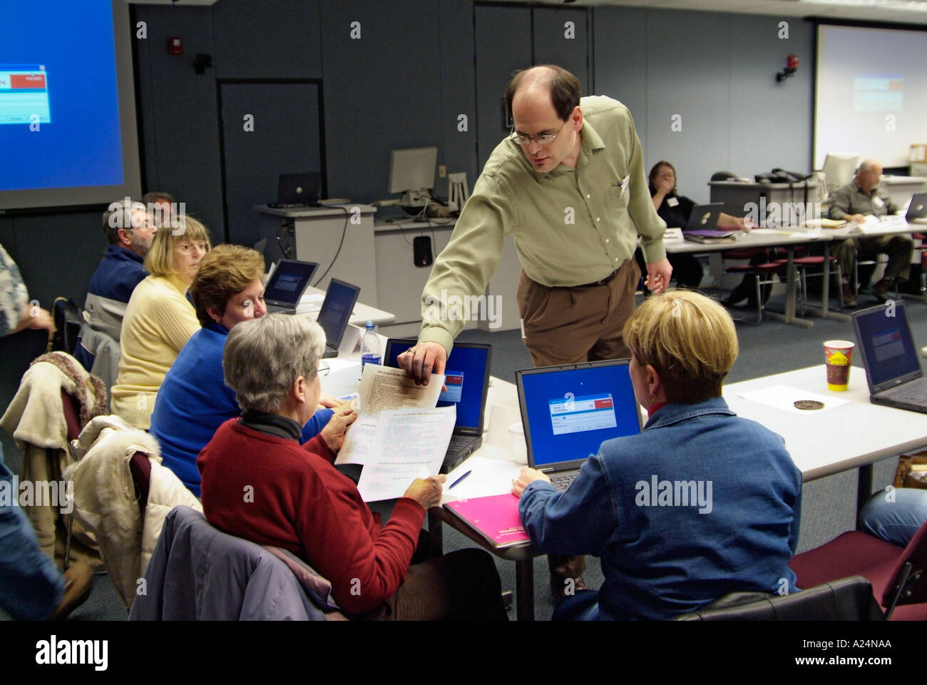 Adult computer class training is conducted during a business meeting ...