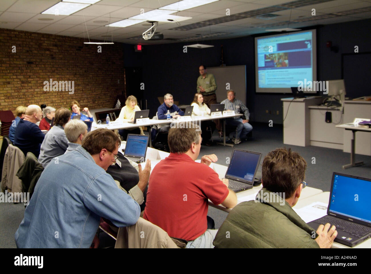 Adult computer class training is conducted during a business meeting ...