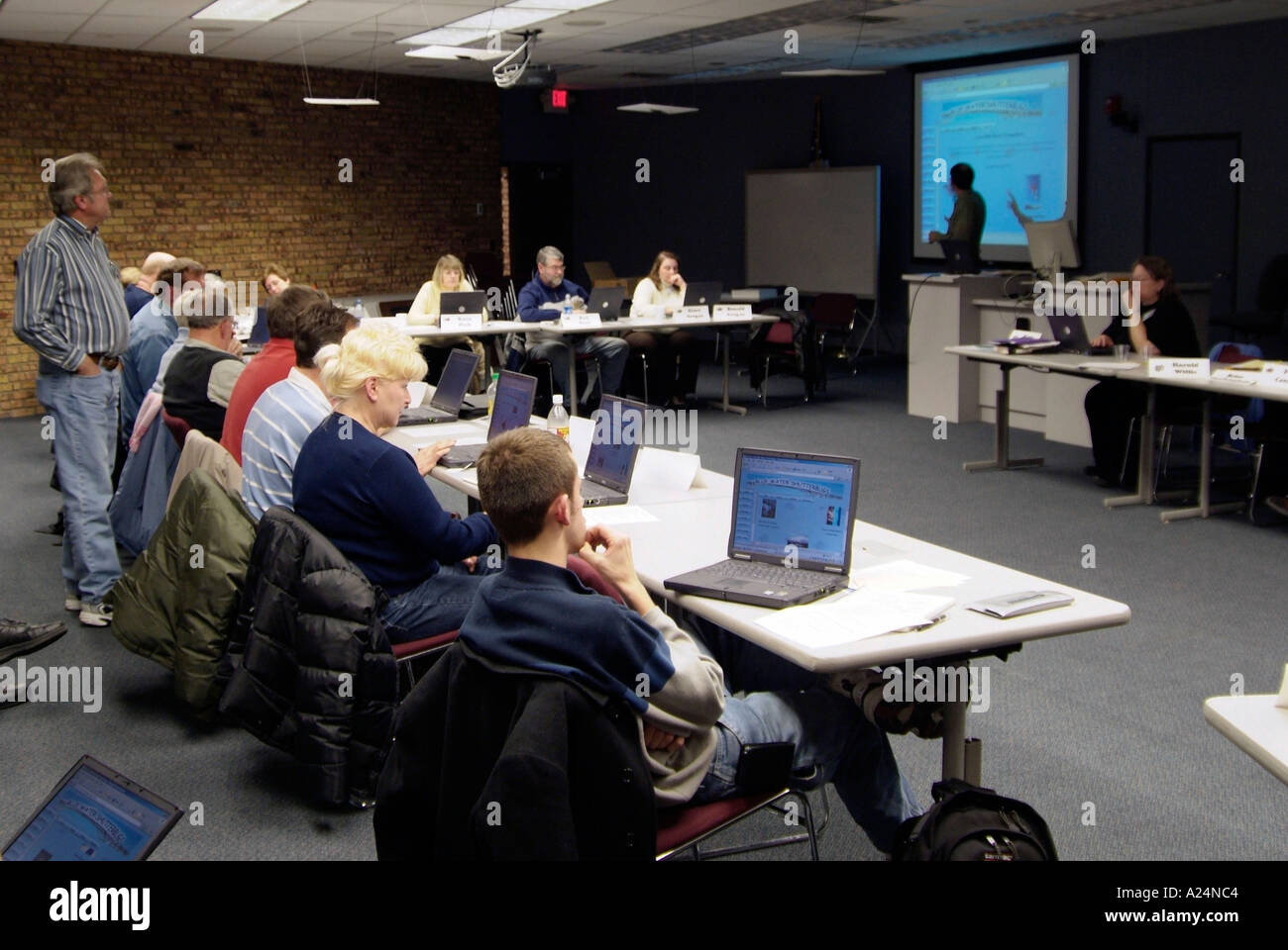 Adult computer class training is conducted during a business meeting ...