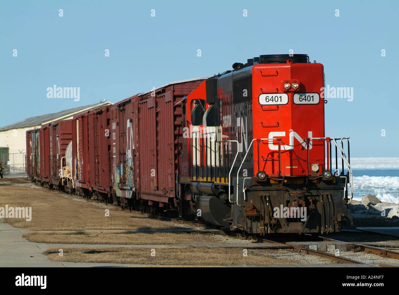 Diesel locomotive train pulling box cars on a railroad track Stock ...
