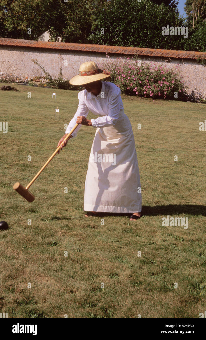 Croquet game players in Victorian Dress Lawn Grass Hoop Ball Mallet Man ...