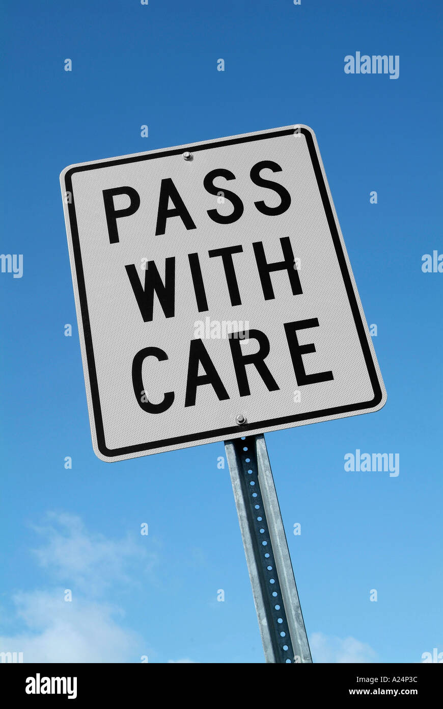 Pass with care warning street sign Stock Photo - Alamy