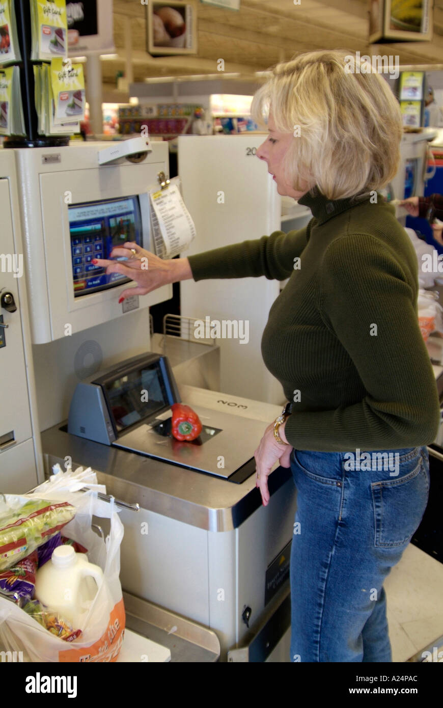 Female uses self serve check out in a modern grocery super store Stock ...