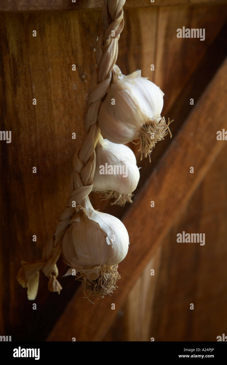 garlic hanging on back of a wooden door Stock Photo - Alamy