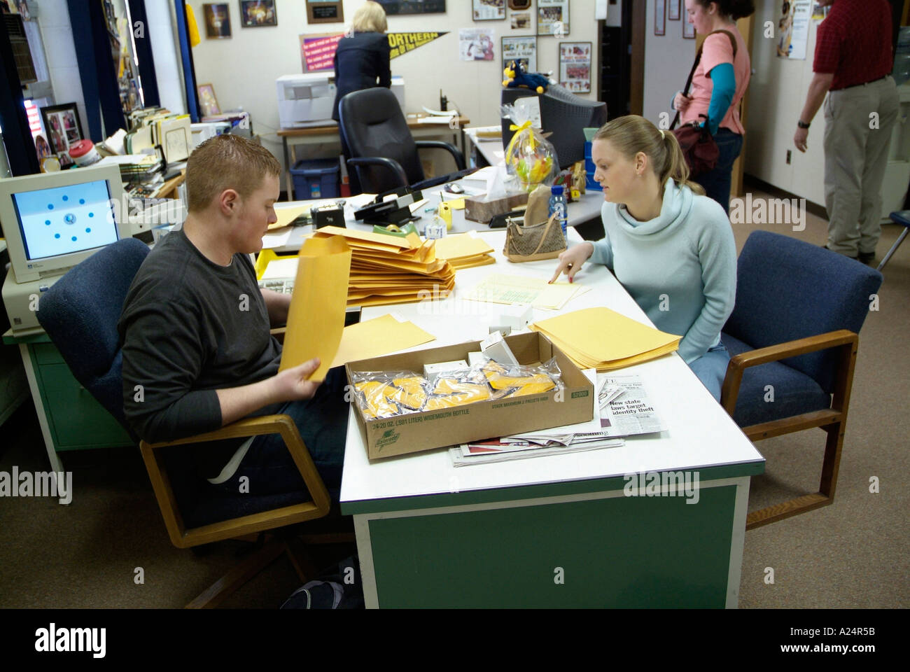 High school students work on project at a desk Stock Photo - Alamy