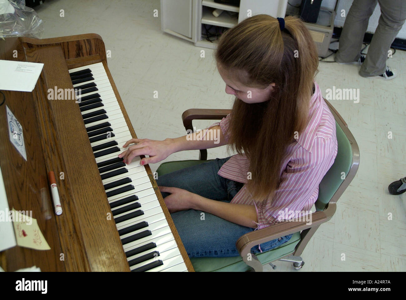 Female high school student practices music on the piano Stock Photo - Alamy