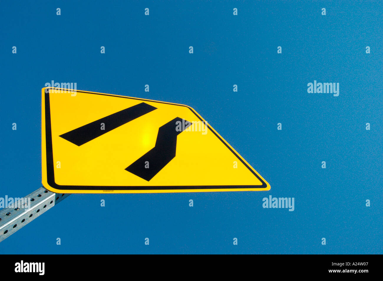 Freeway sign showing merge left as lane ends Stock Photo - Alamy