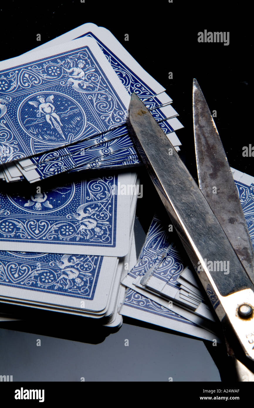Cutting the cards with scissors Stock Photo - Alamy