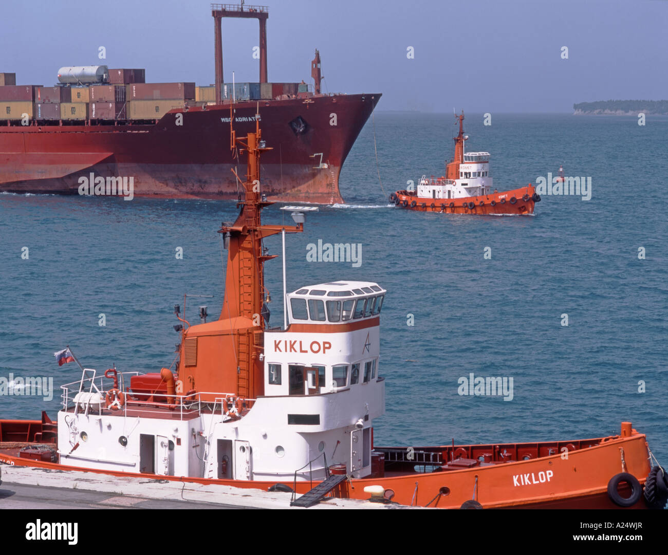 Koper, Primorska, Slovenia. Tug boat pulling large container ship in ...