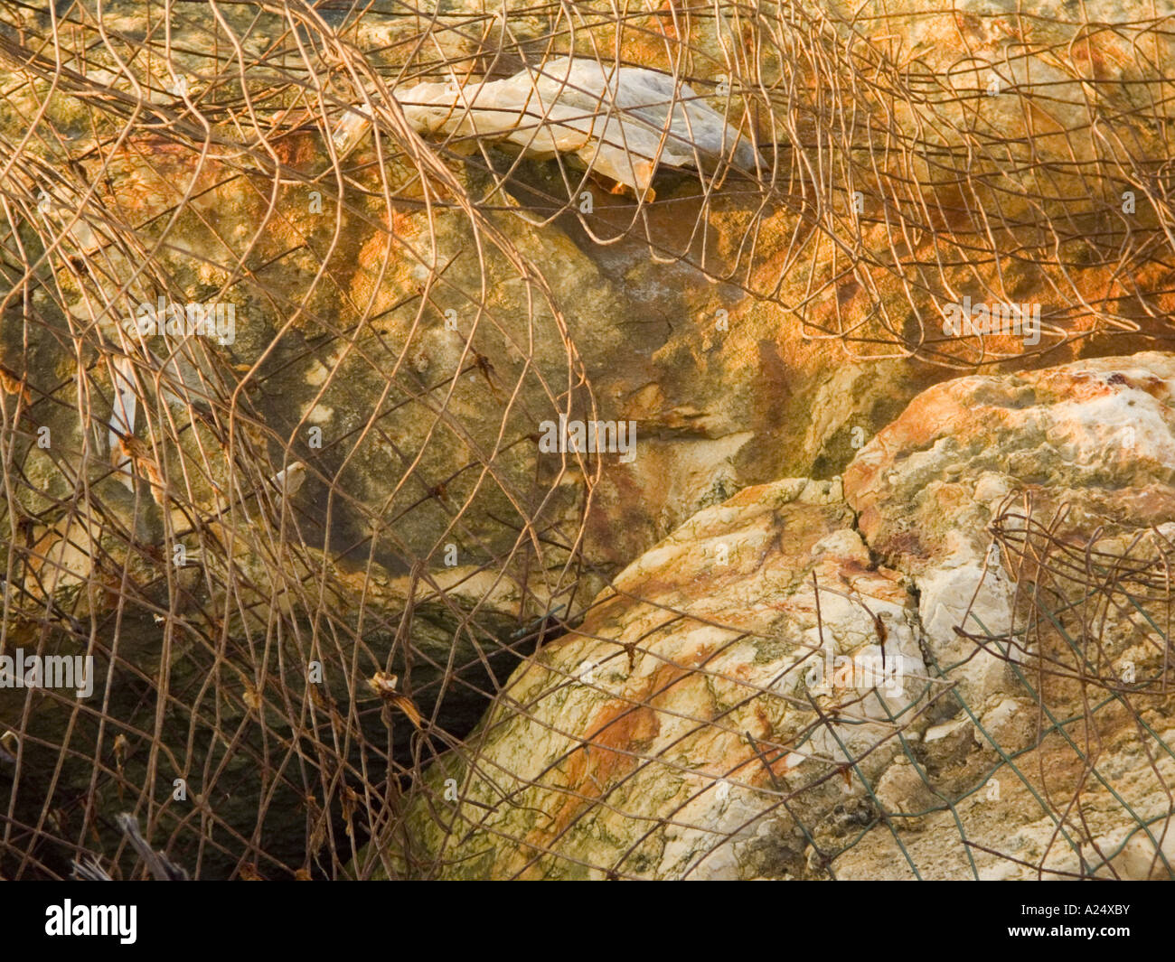rust net background on the rocks of Villaggio coppola, pollution of ...
