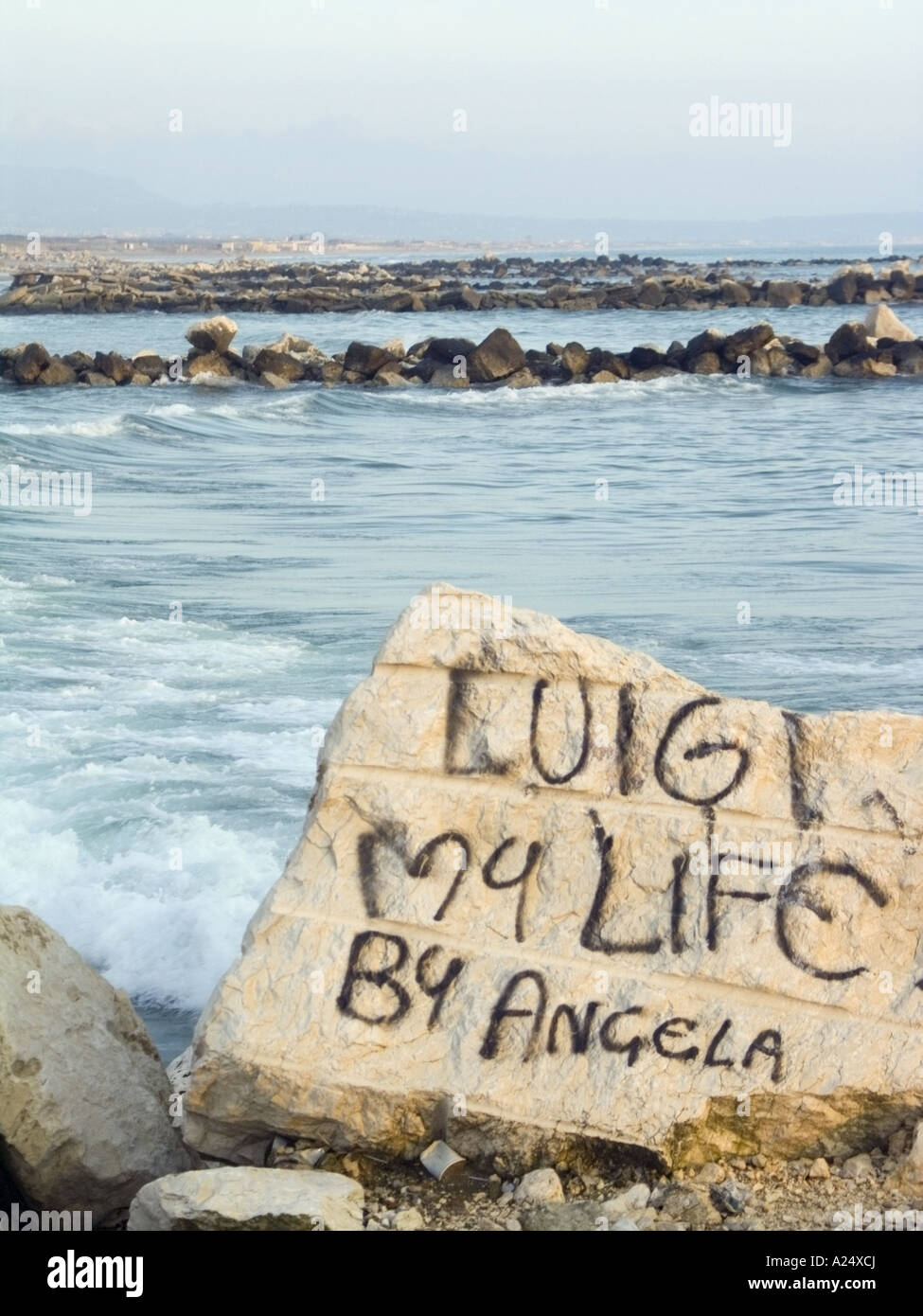 love murales on a rock the beach of Villaggio coppola, pollution of ...