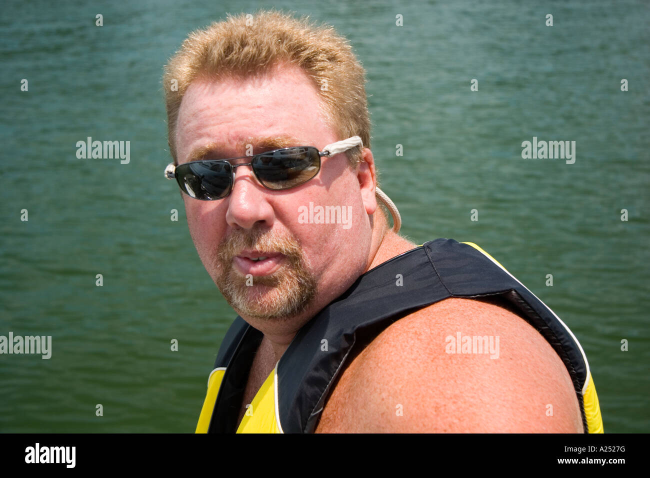 Man wearing life jacket and sunglasses Stock Photo - Alamy