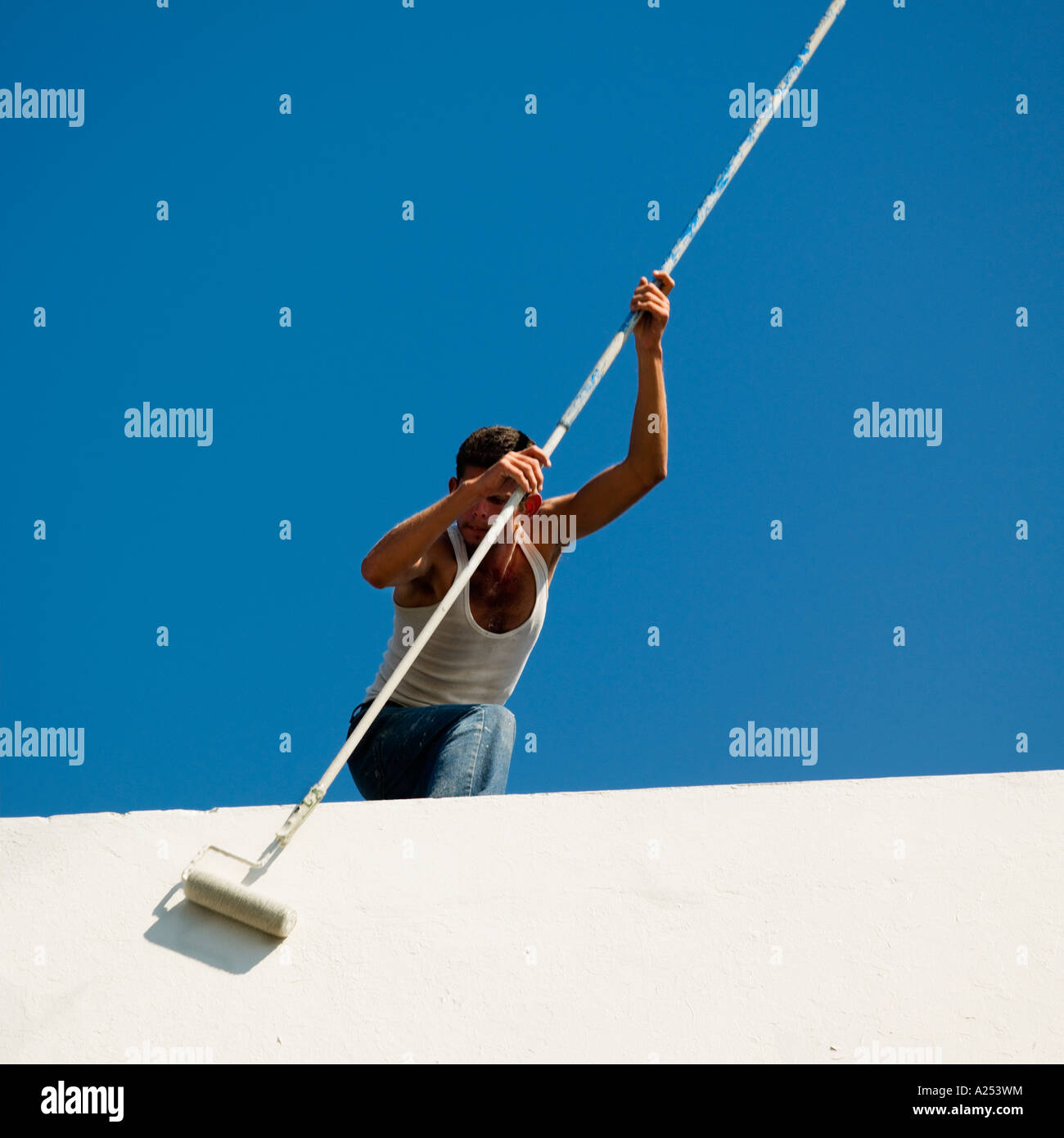 Painters painting the side of a building white Stock Photo - Alamy