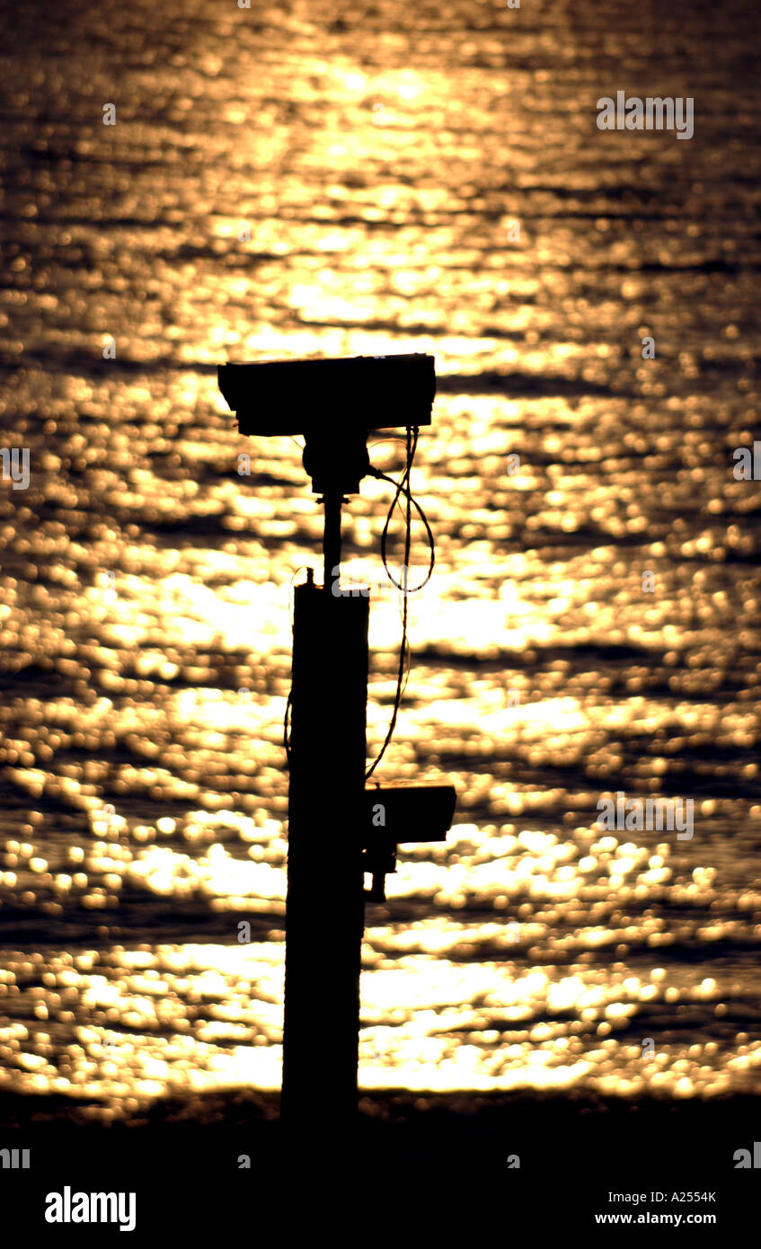 A CCTV camera silhouetted against the sea along Brighton seafront UK ...