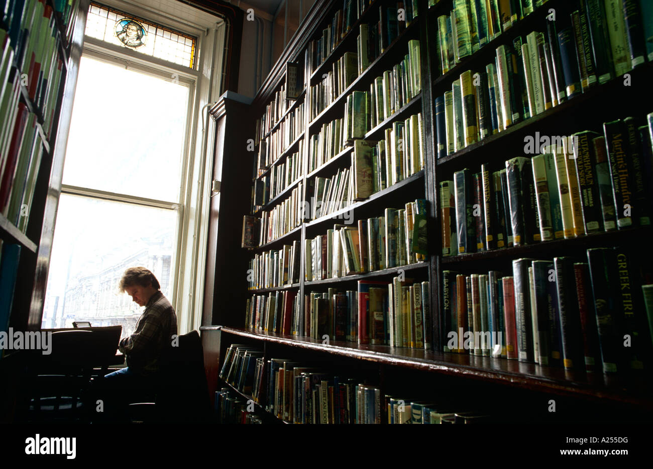 A reader reads through books in the Linen Hall Library in Belfast City ...