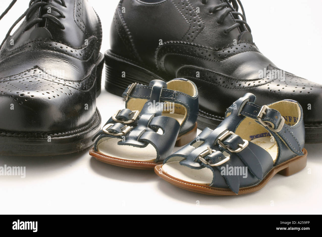 Man and Children's Shoes Stock Photo - Alamy
