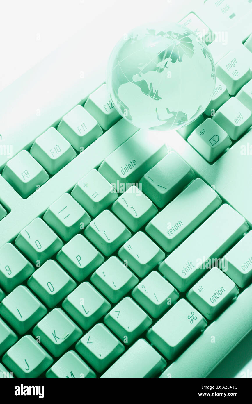 Crystal Globe on Computer Keyboard Stock Photo - Alamy