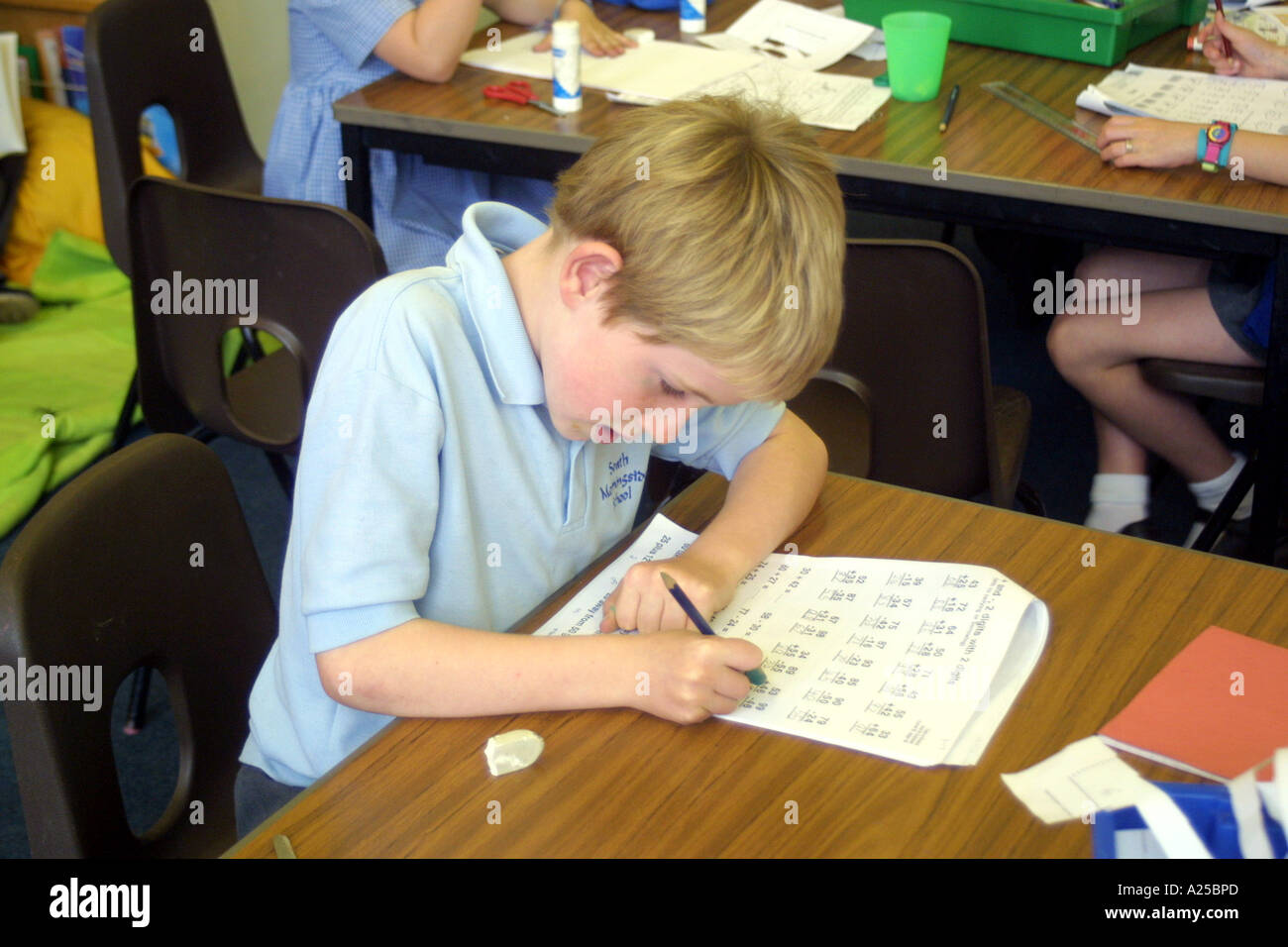 Primary school boy in second year taking a math test in class Stock ...