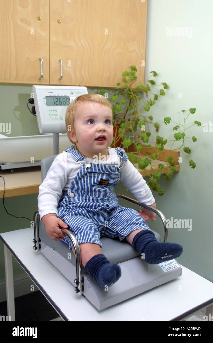 13 month old baby being weighed in the clinic Stock Photo - Alamy
