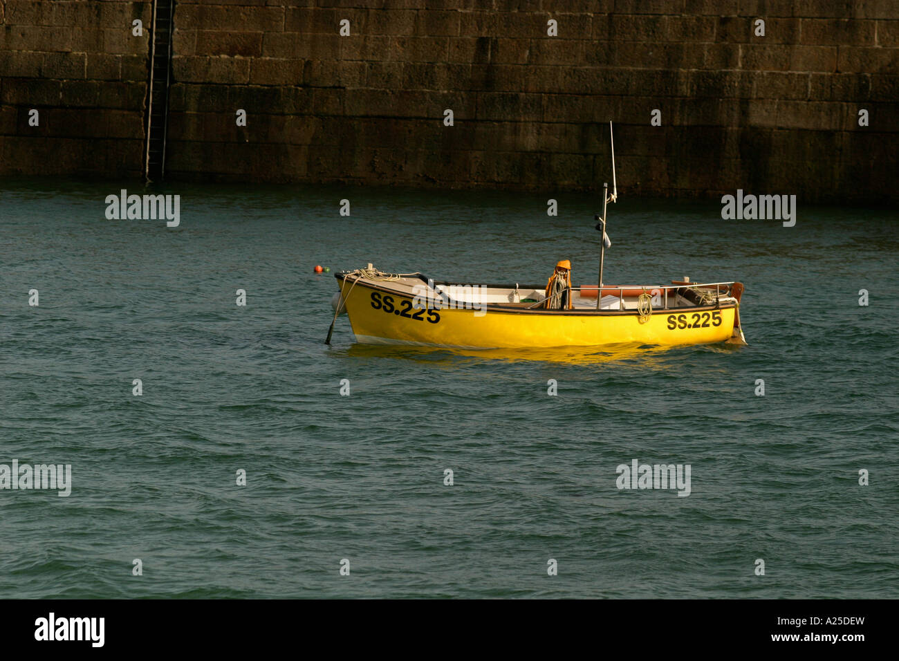 Small yellow boat moored in St. Ives harbour Cornwall UK Stock Photo ...