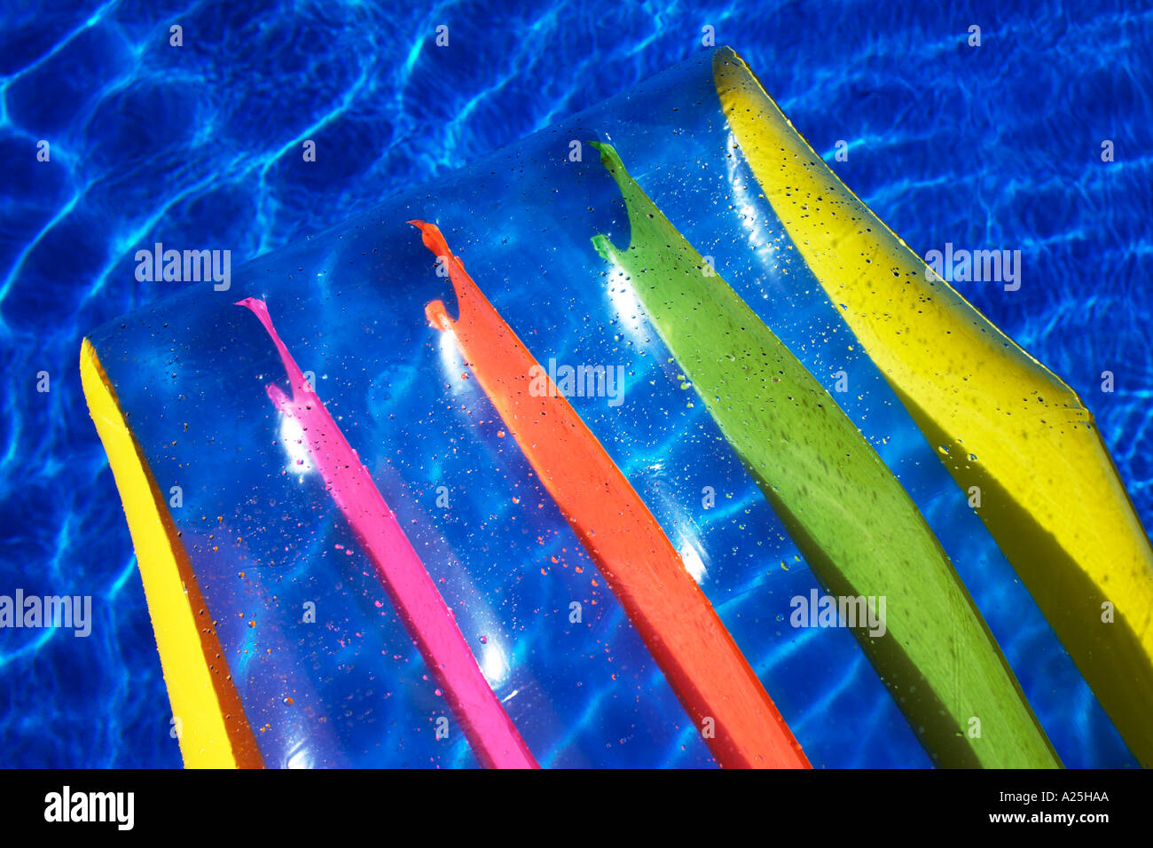 Colourful colorful lilo in swimming pool Stock Photo - Alamy