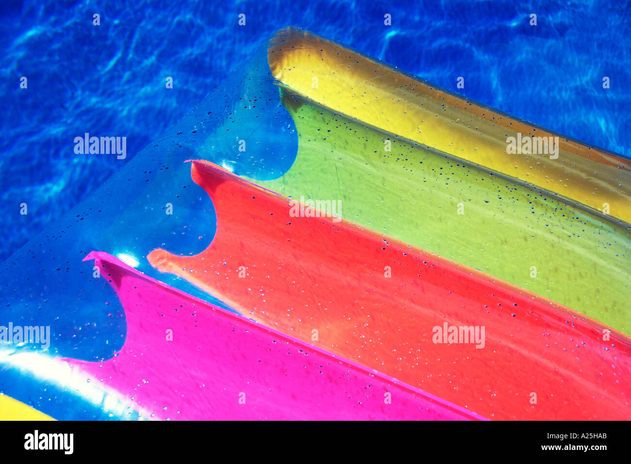 Colourful colorful lilo in swimming pool Stock Photo - Alamy