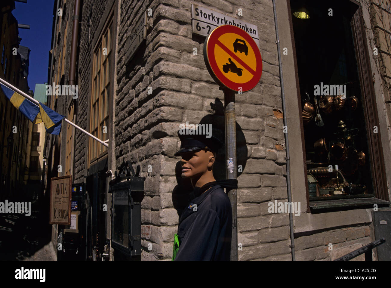 no thoroughfare sign and a dummy with hat in front of a shop on a ...