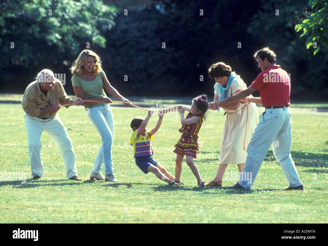 three-generation-family pulling rope Stock Photo - Alamy