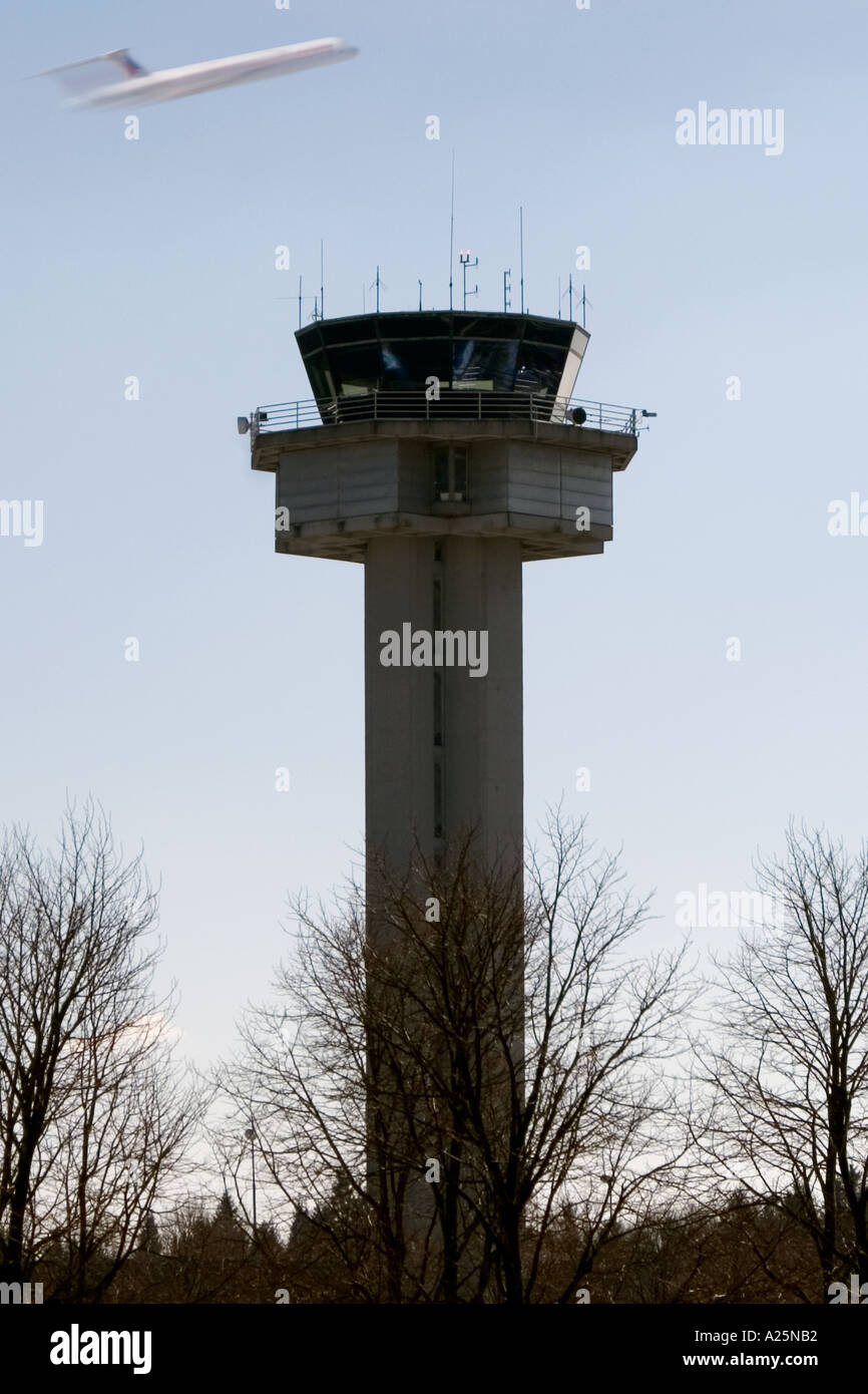 Airplane over control tower Stock Photo - Alamy